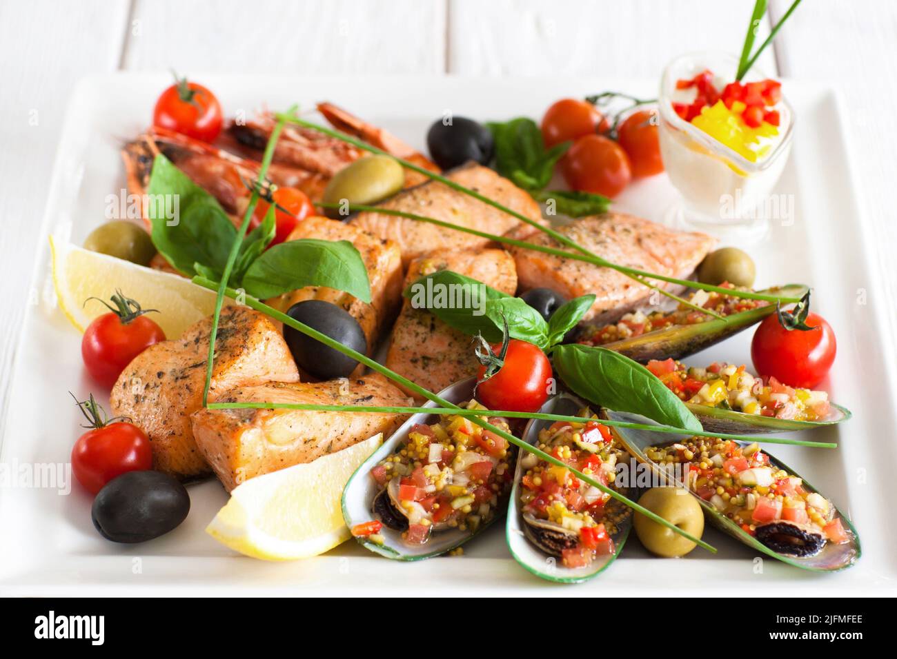 Close-up of plate with assorted cooked seafood Stock Photo - Alamy