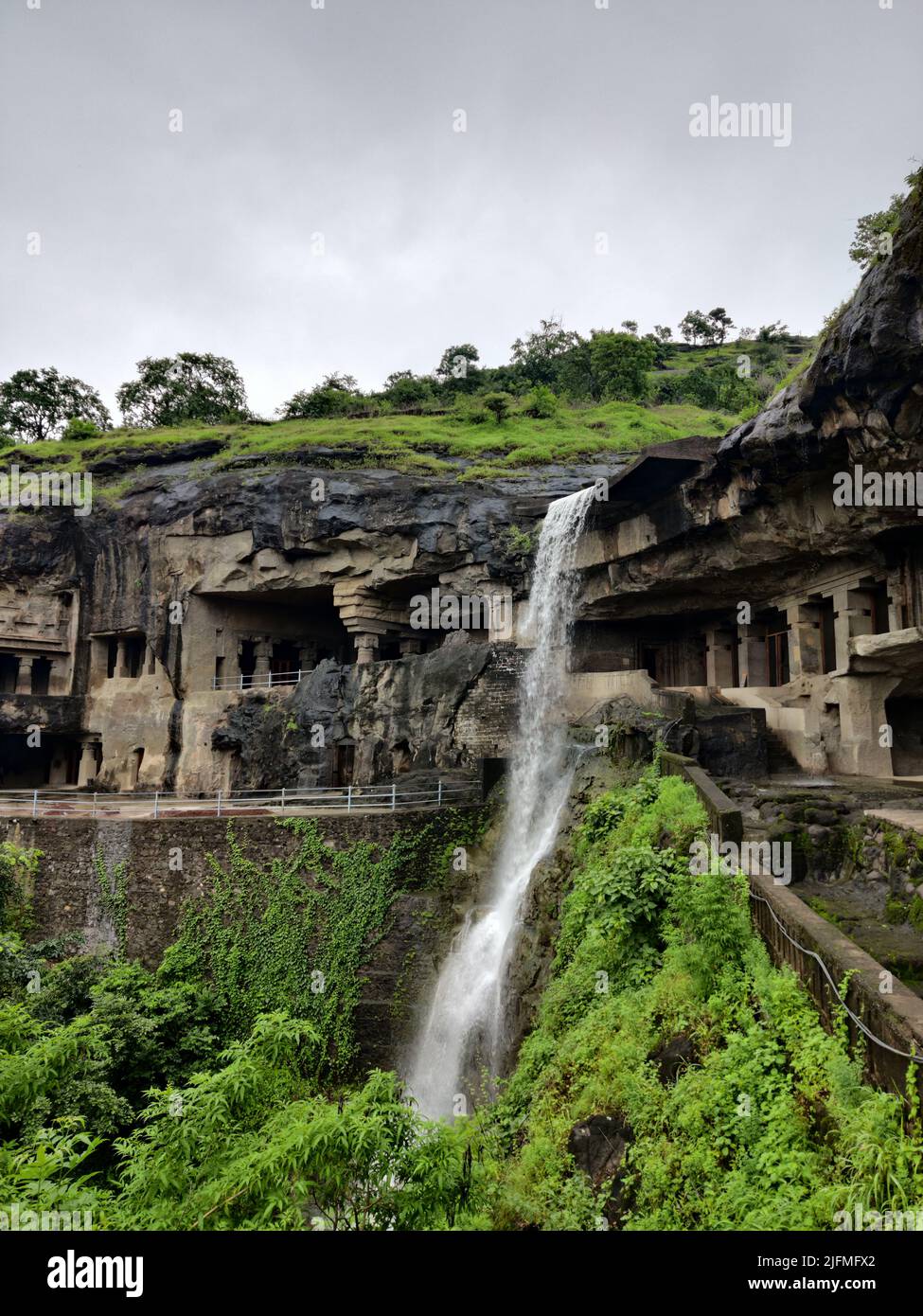 A landscape of waterfall on mossy caves in Ellora caves in Verul, India ...