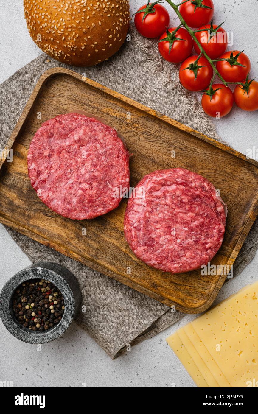 Raw BBQ Beef Burger Cutlets on gray stone table background, top view ...