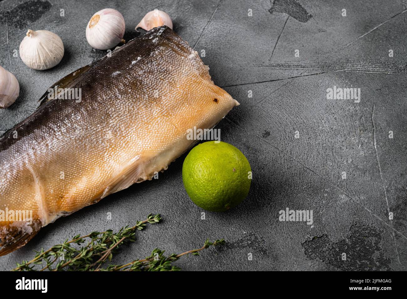 Whole smoked trout fish, on gray stone table background, with copy ...