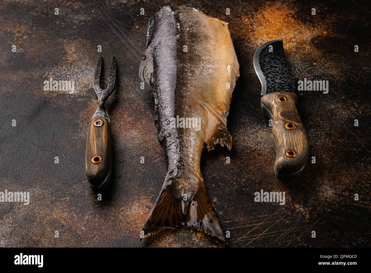 Cold smoked fish trout or salmon, on old dark rustic table background ...