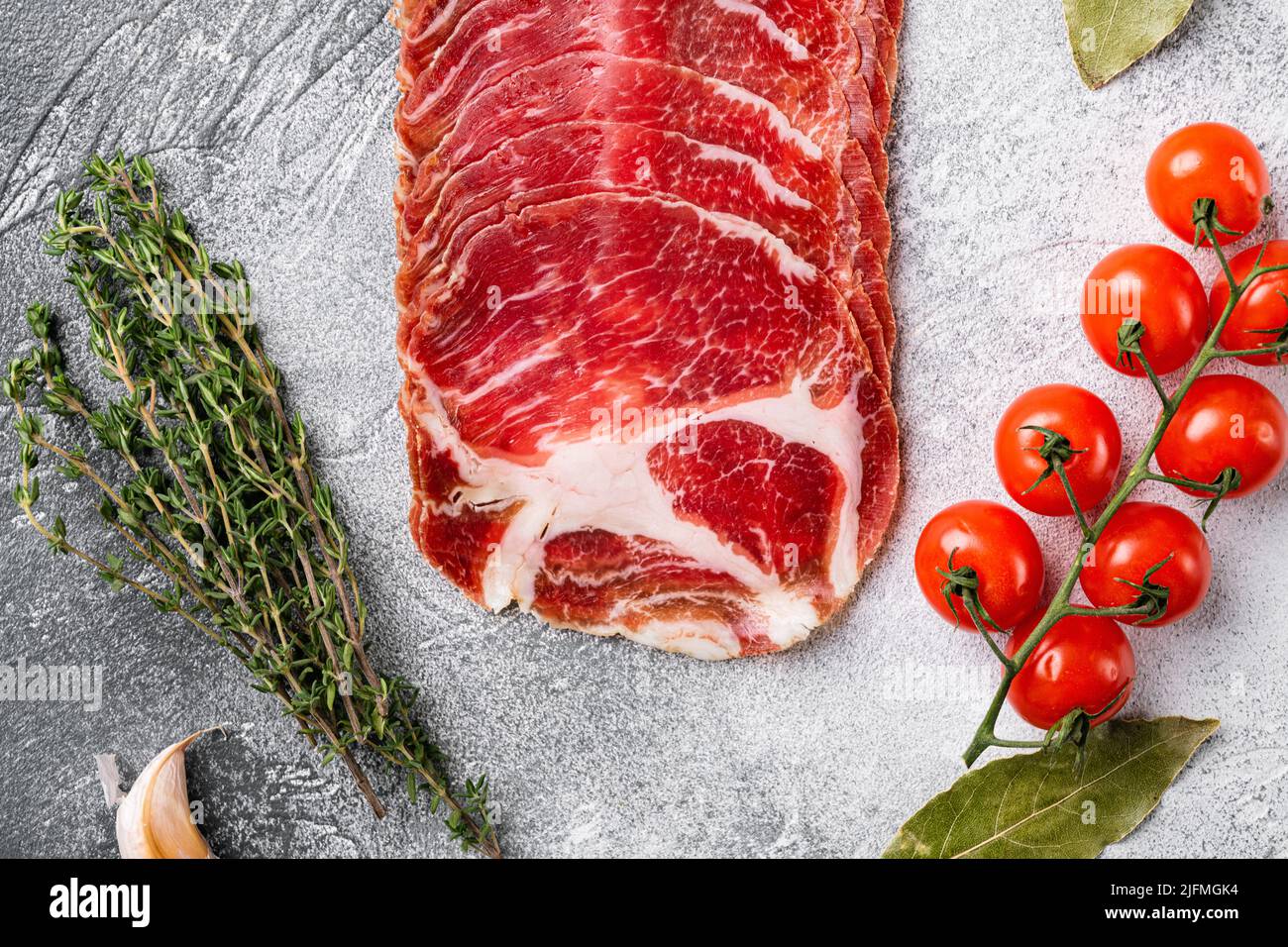 Italian cured meat slices coppa, on gray stone table background, top ...