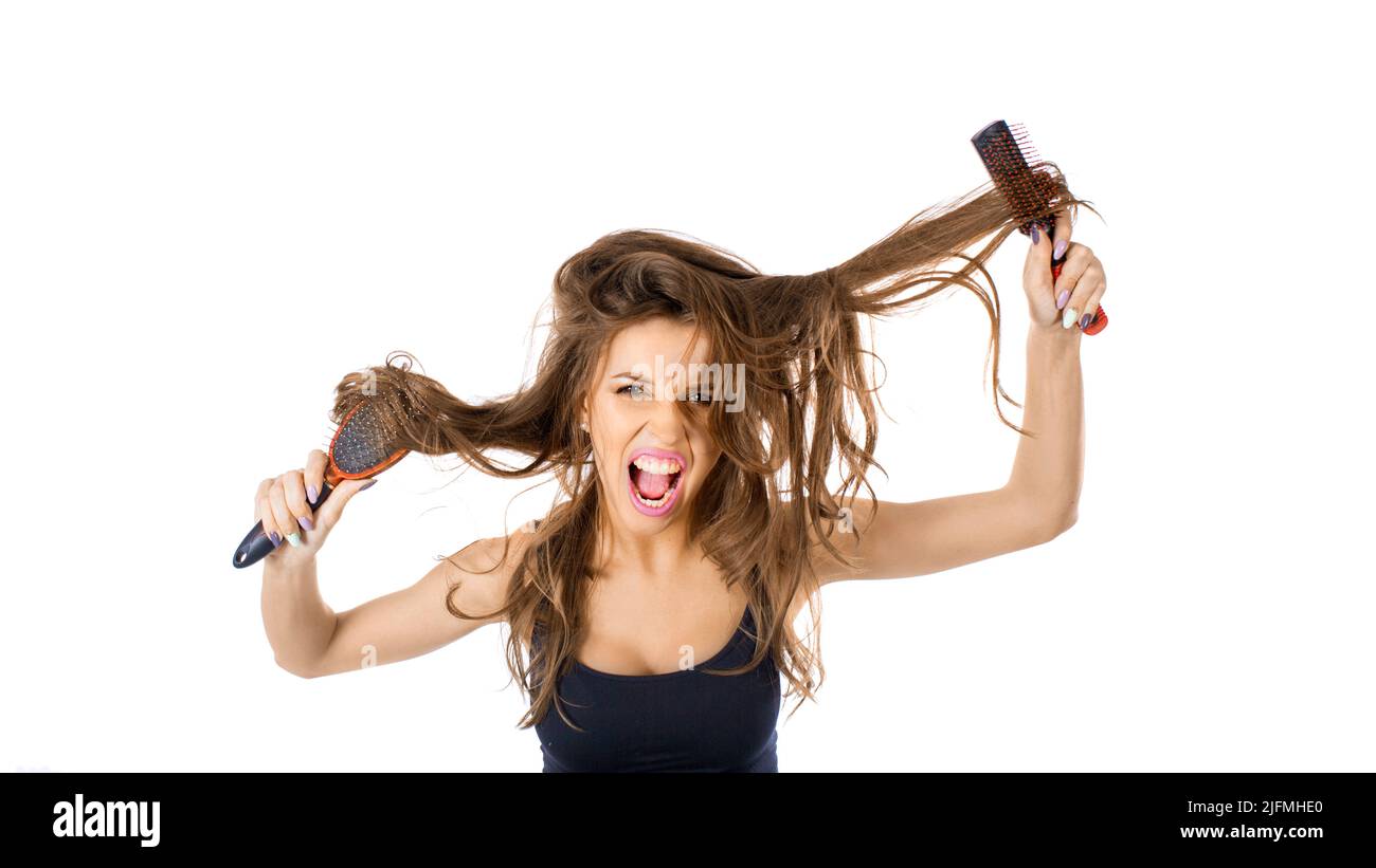Young beautiful girl having problems while hair. Isolated studio shot ...