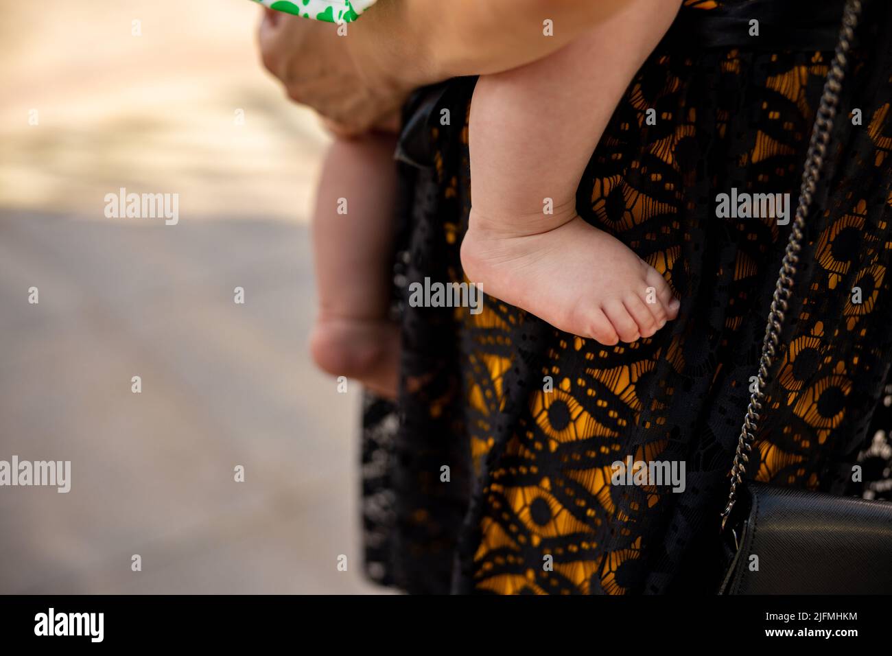 The sacrament of the baptism of a child in an Orthodox church, the baby's feet in a white veil ...