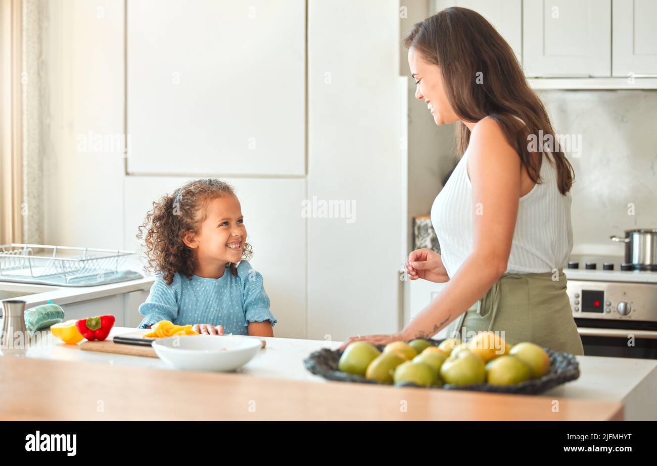 Mother And Little Daughter Talking While Mom Teach Her How To Cook A Vegetarian Meal Cooking
