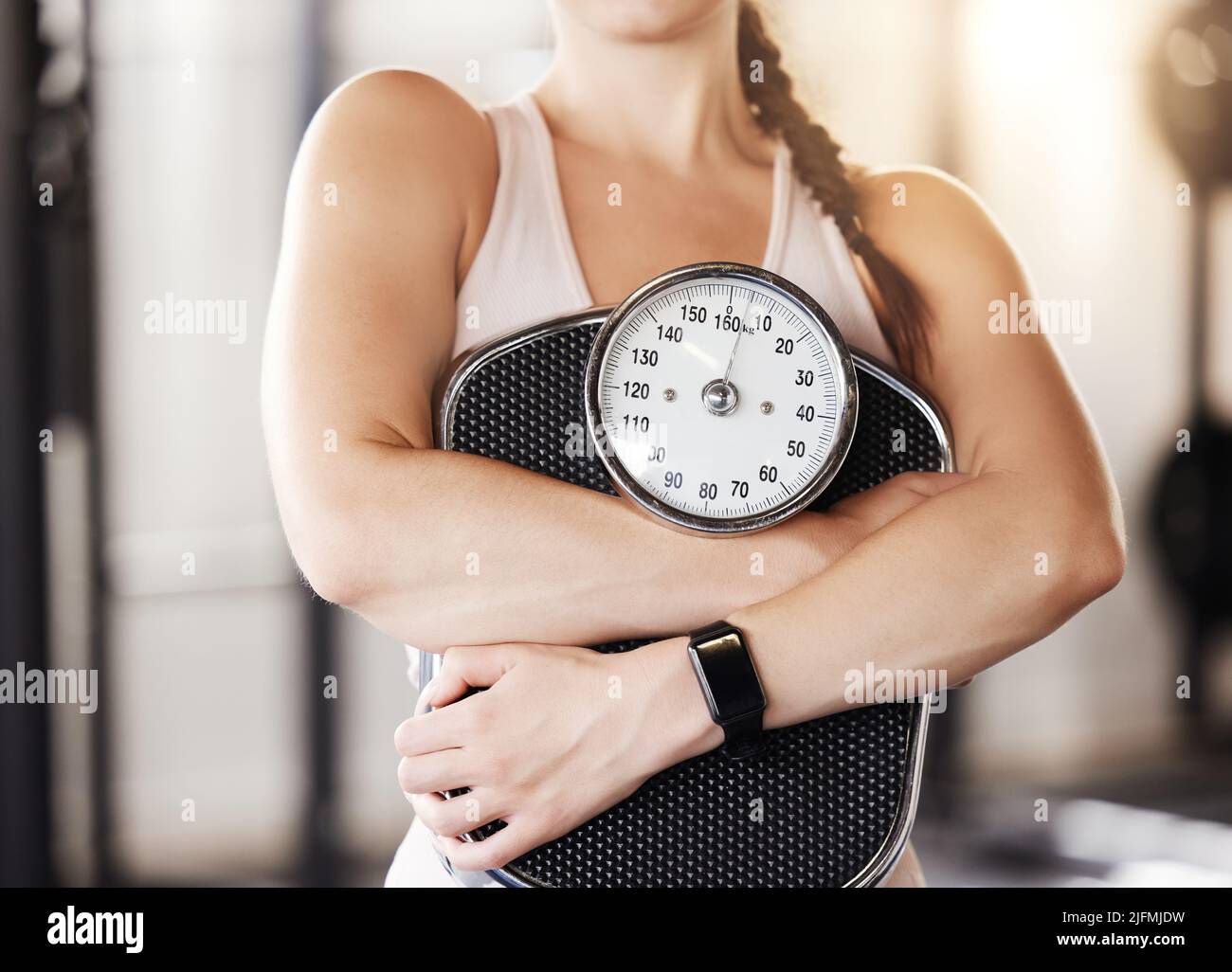 Woman hugging weight scale hi-res stock photography and images - Alamy