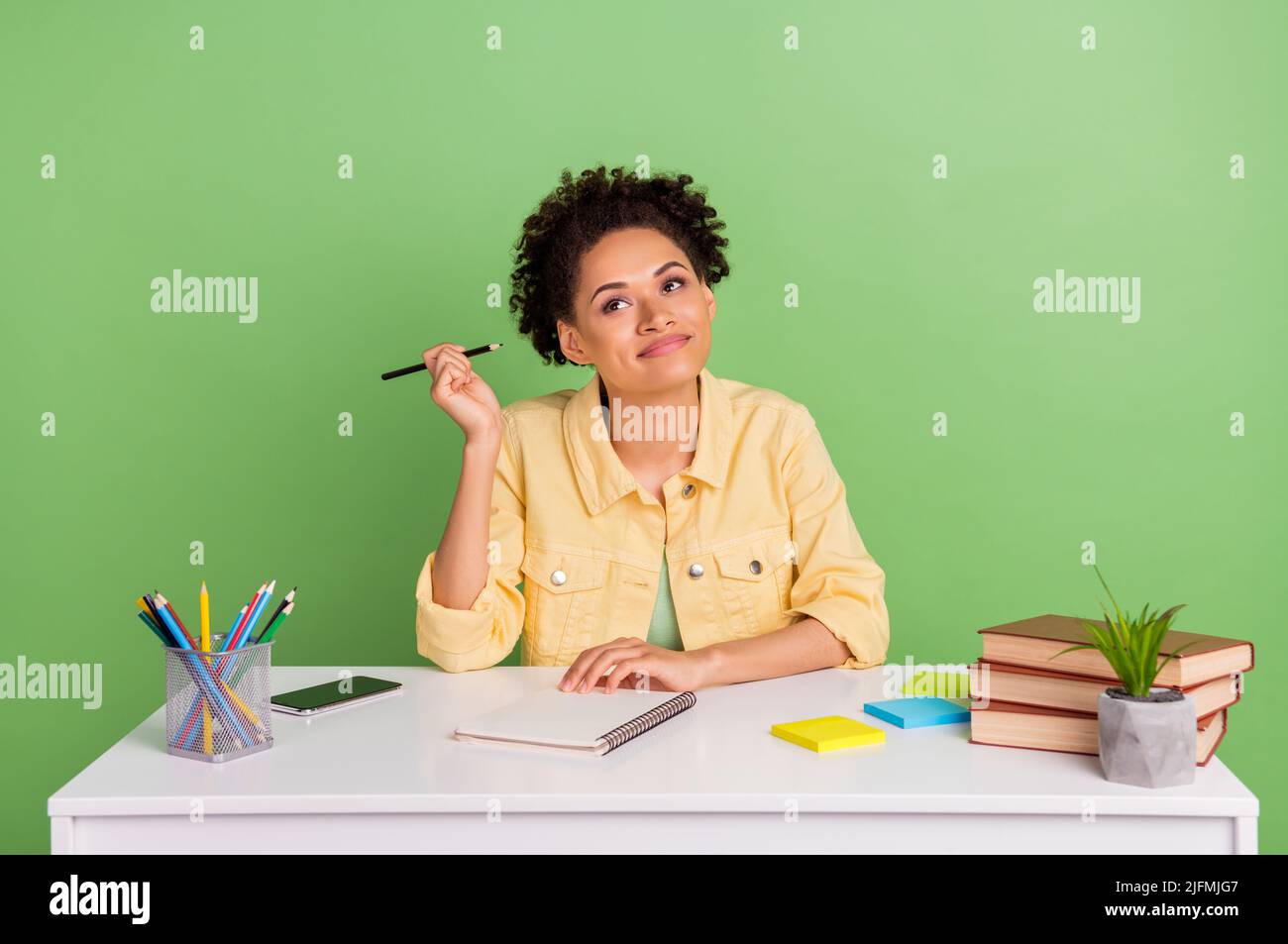 Photo of smart millennial brunette lady sit work wear yellow shirt ...