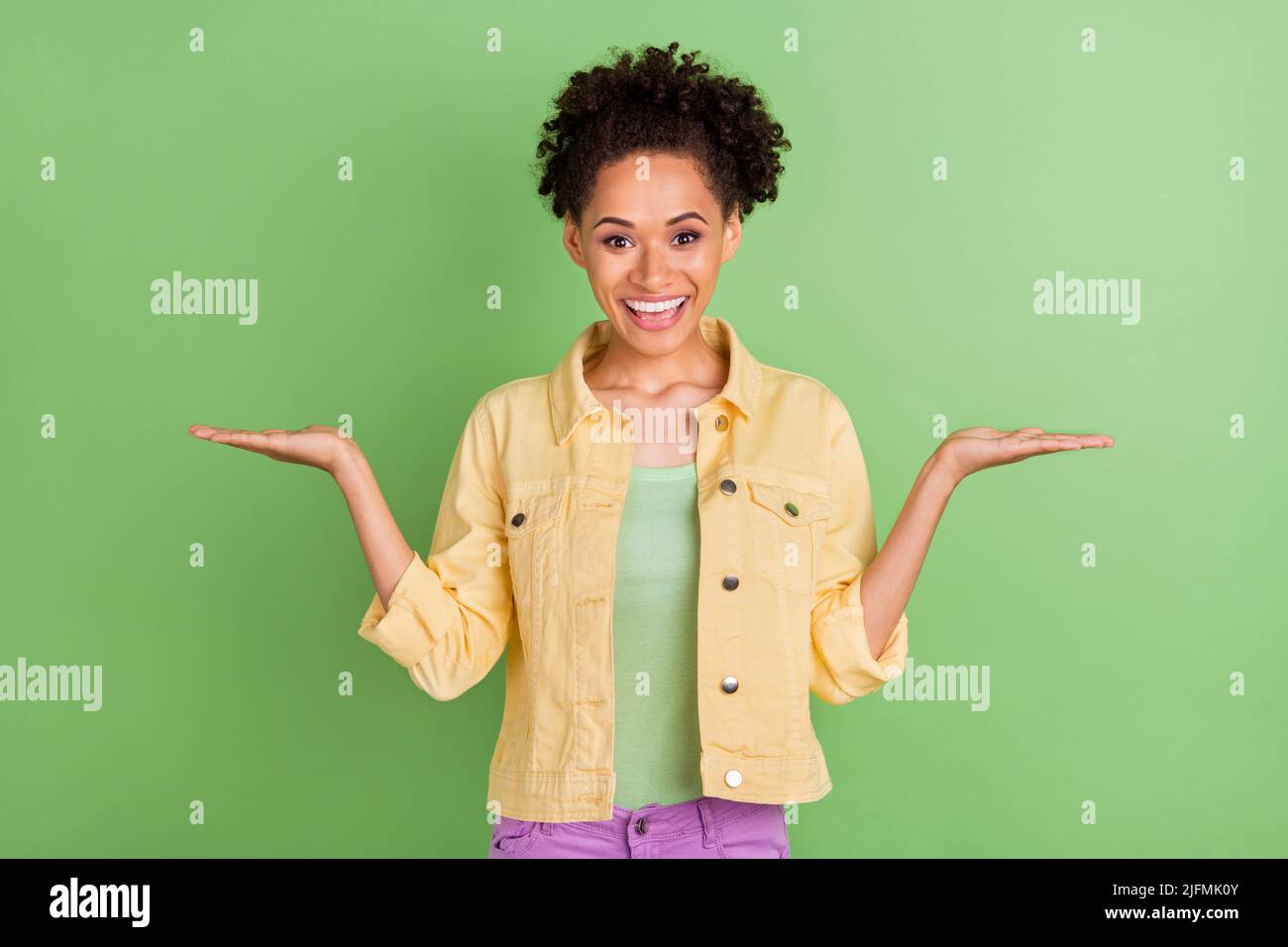 Photo of cool young brunette lady hold hands wear yellow shirt isolated ...