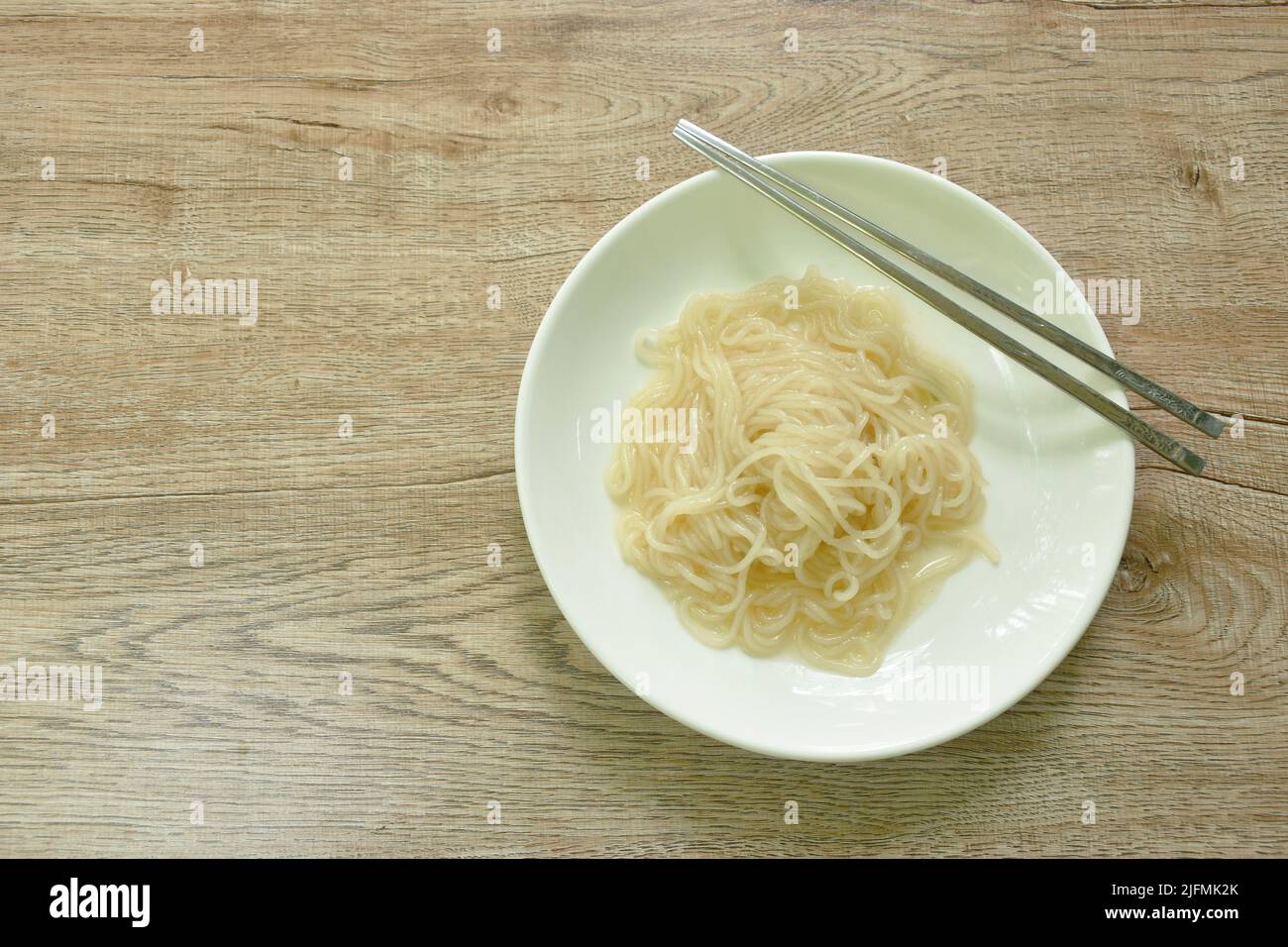dry Vietnamese rice noodles or Pho with soup on plate Stock Photo - Alamy