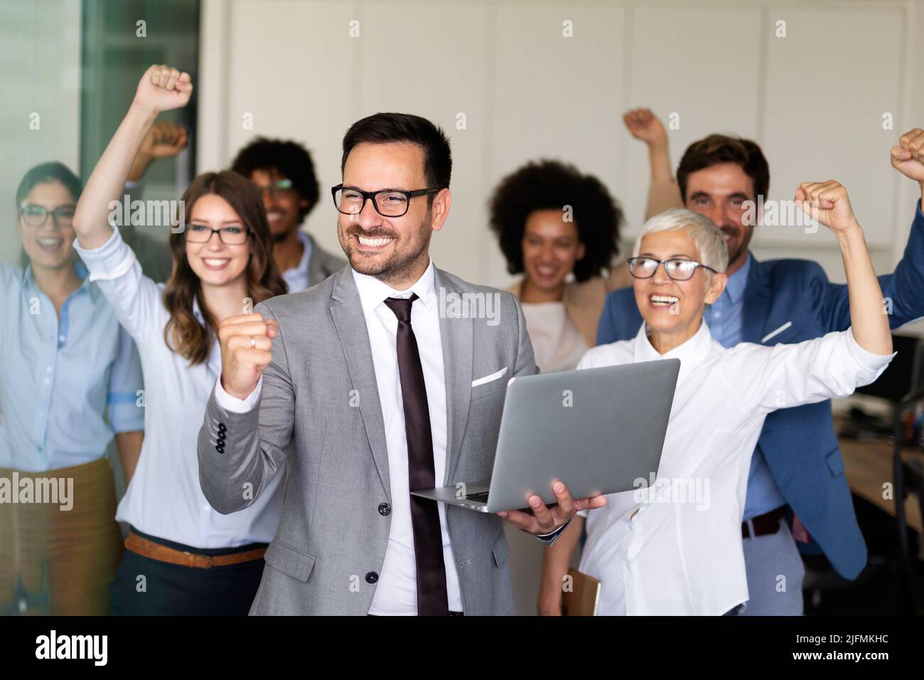 Group of successful multiethnic business people celebrating a good job ...