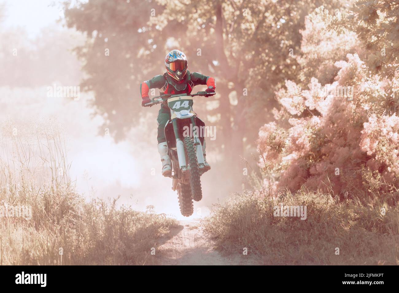 Live shot of male sportsman training on motorbike at hot summer day ...