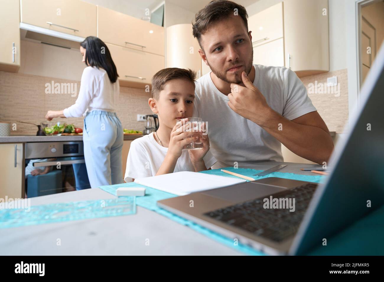 Kid with glass sitting near father, confused with son homework Stock ...