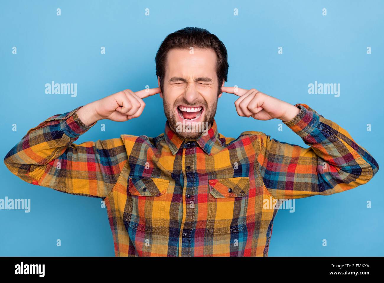 Photo of annoyed upset young man wear plaid shirt closed eyes fingers ...