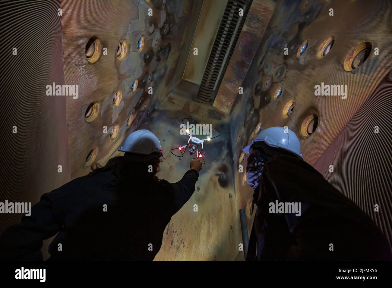 Drone male inspection operated by construction worker on furnace in ...