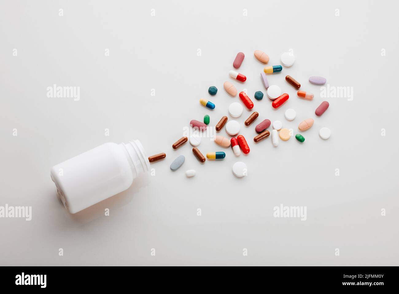 Drug abuse is a serious problem. High angle shot of a pill bottle lying ...