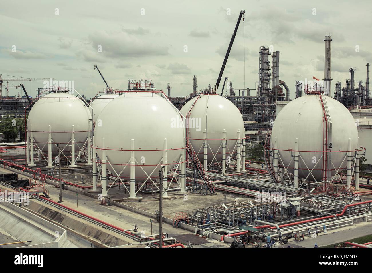 White spherical propane tanks containing fuel gas pipeline and ...