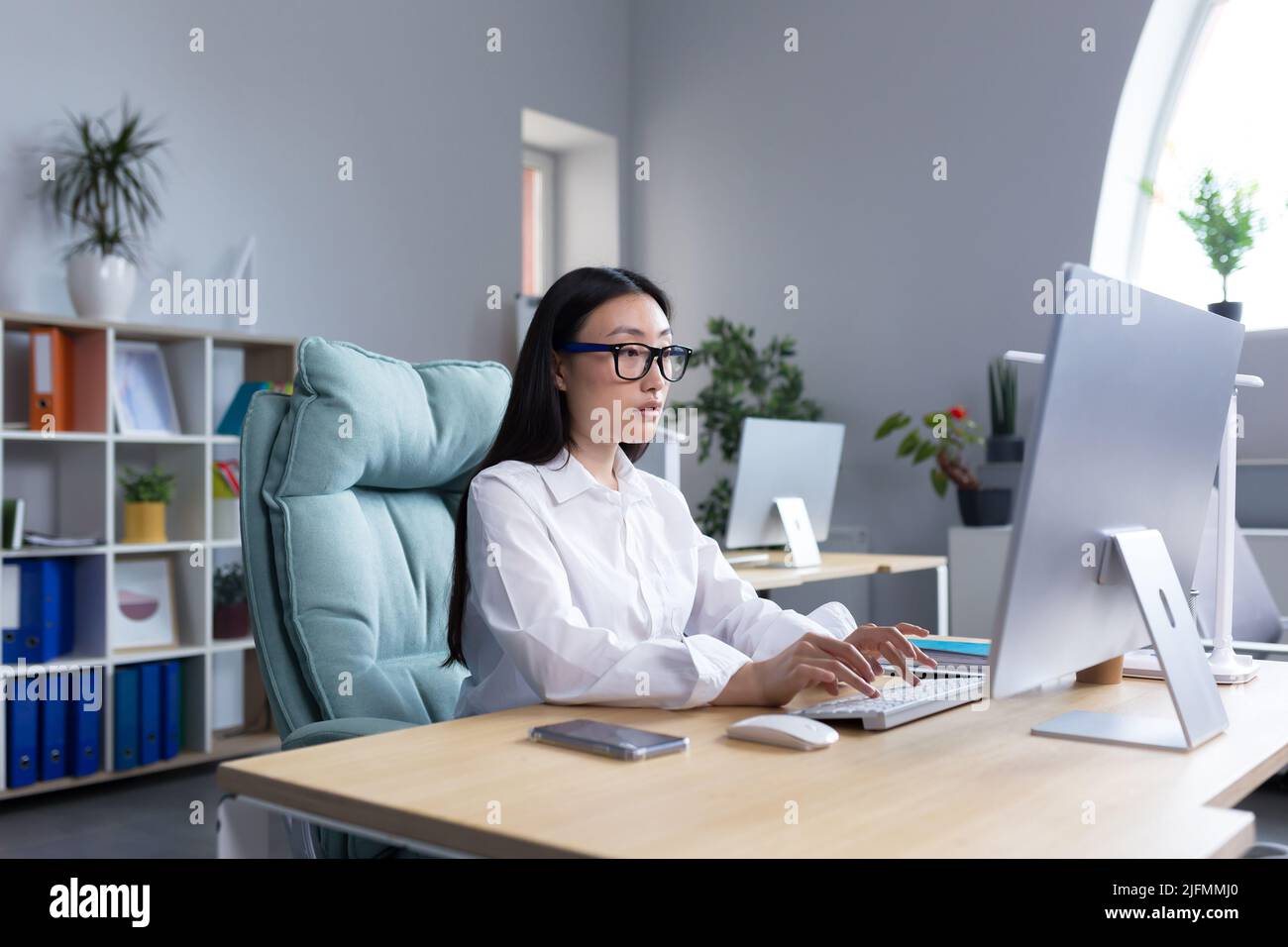 Secretary typing paperwork hi-res stock photography and images - Alamy