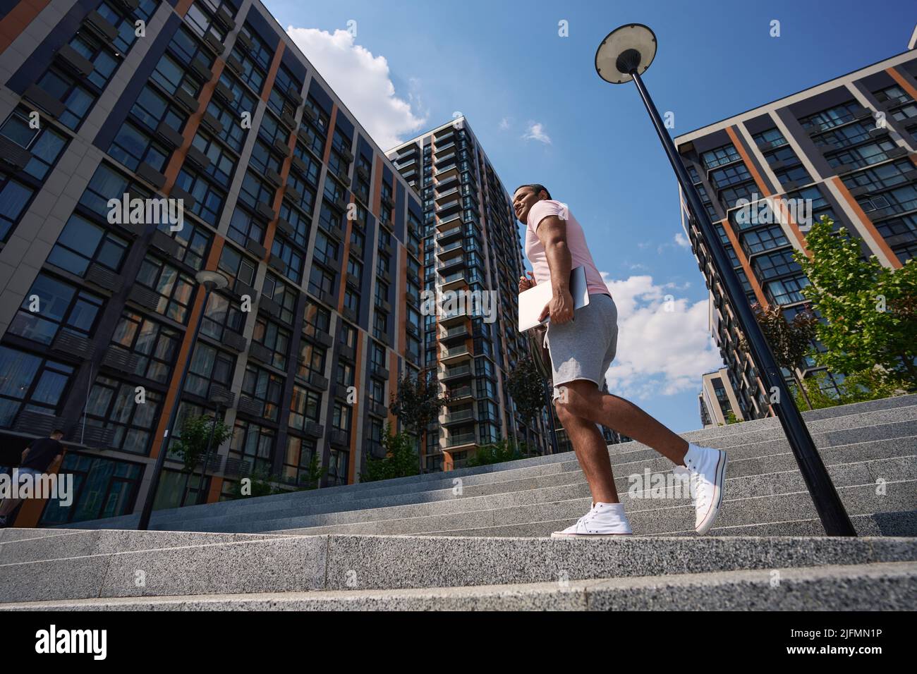 Young worker going up stairs hi-res stock photography and images - Alamy