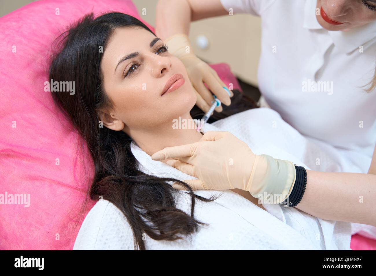 Doctor makes anti-aging injections for the skin of the neck Stock Photo ...