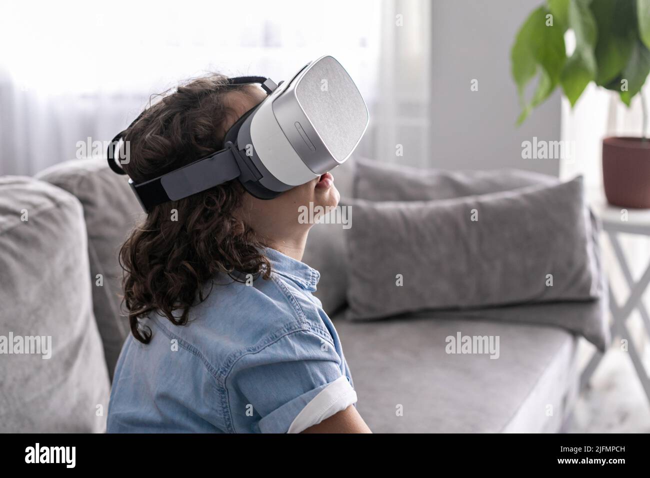 close up happy little boy child using virtual reality headset vr ...