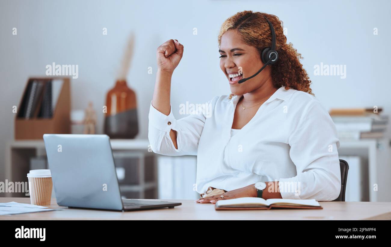 Happy and cheerful mixed race female call center agent cheering in ...