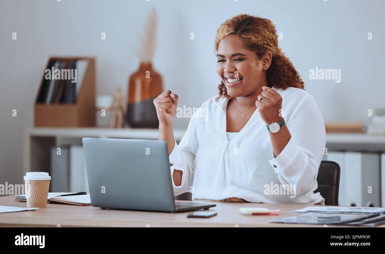 Happy and cheerful mixed race business woman cheering while working on ...