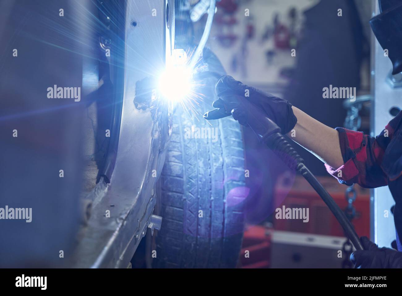 Focused photo on mechanic that welding metal Stock Photo - Alamy