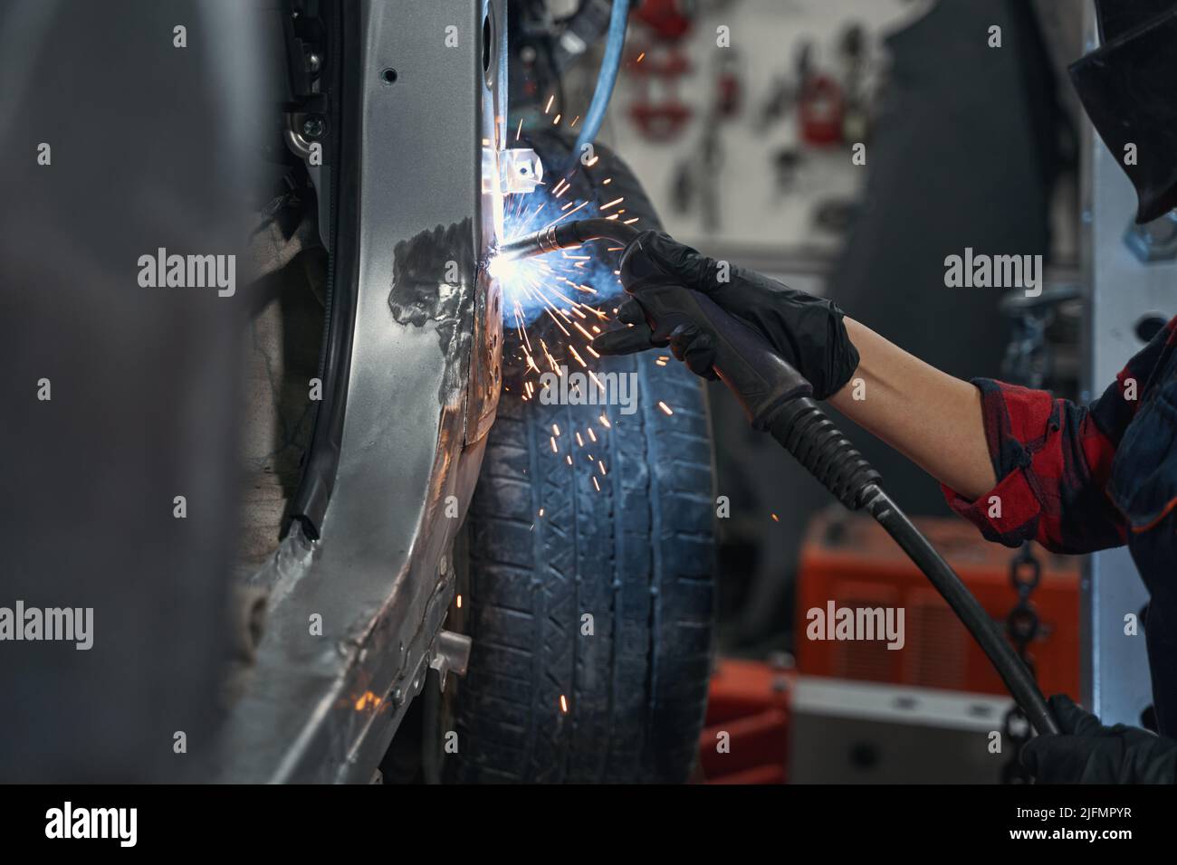 Close up of master holding welding machine Stock Photo - Alamy