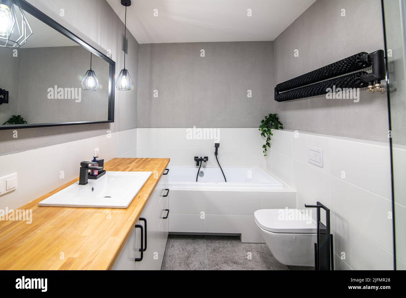 Modern bathroom with a wash basin, a wooden countertop Stock Photo - Alamy