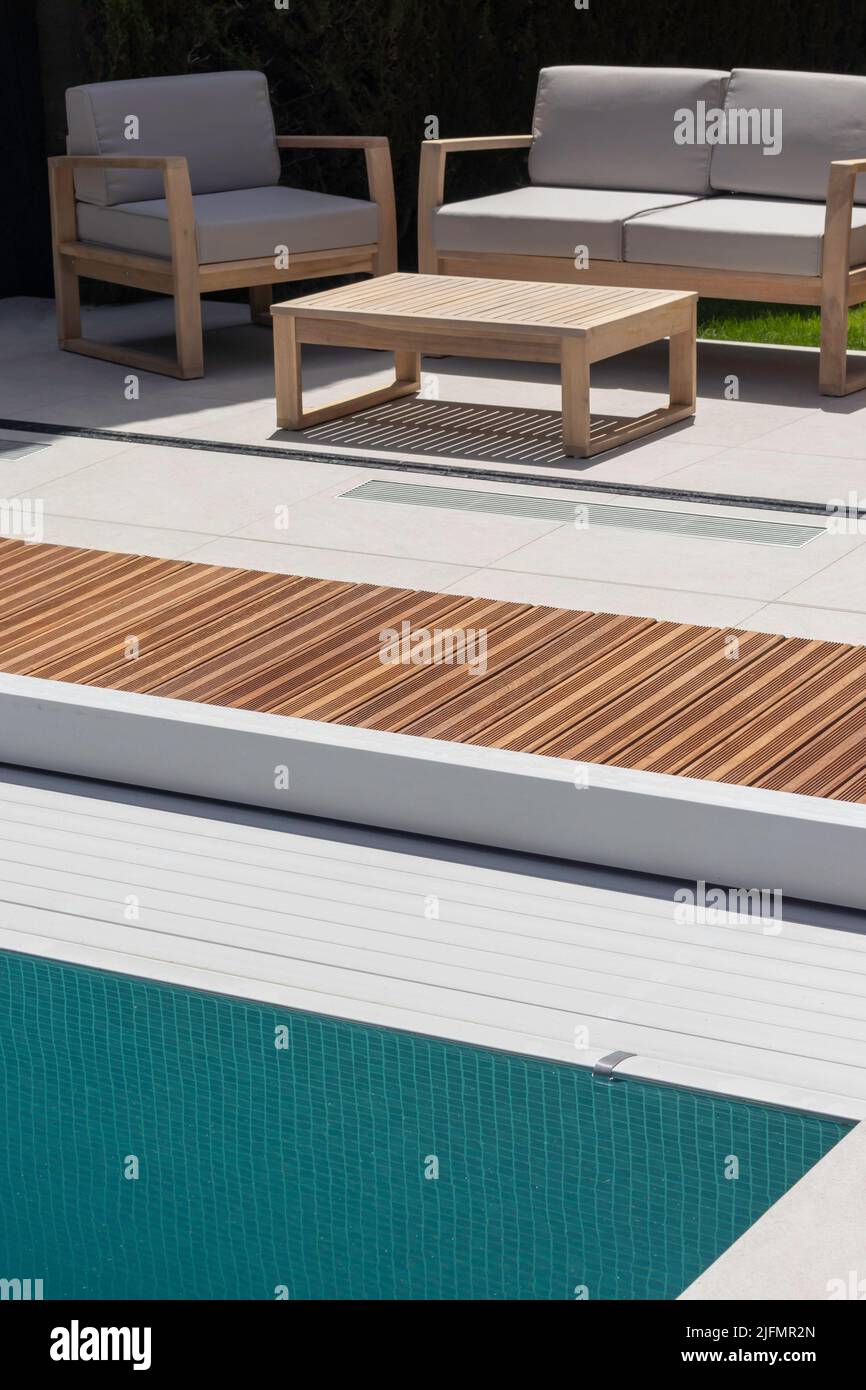 Vertical view of sofa summer lounge area in the swimming pool with ...