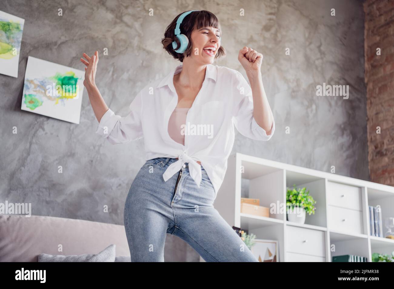 Portrait of attractive funny cheerful girl listening melody pretending ...