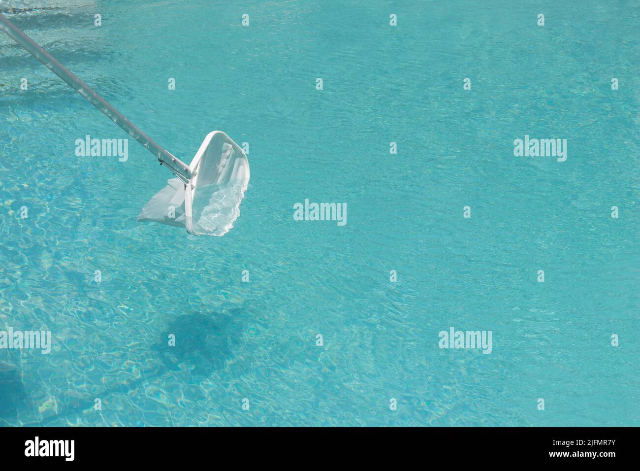 Net cleaning device in isolated pool on water with copy space around ...