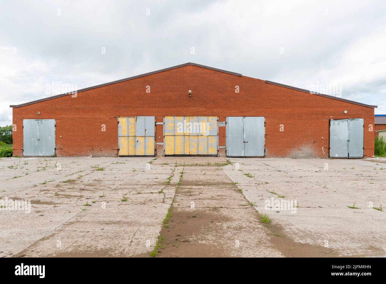 Old closed and abandoned red brick cattle farm building. Rural ...