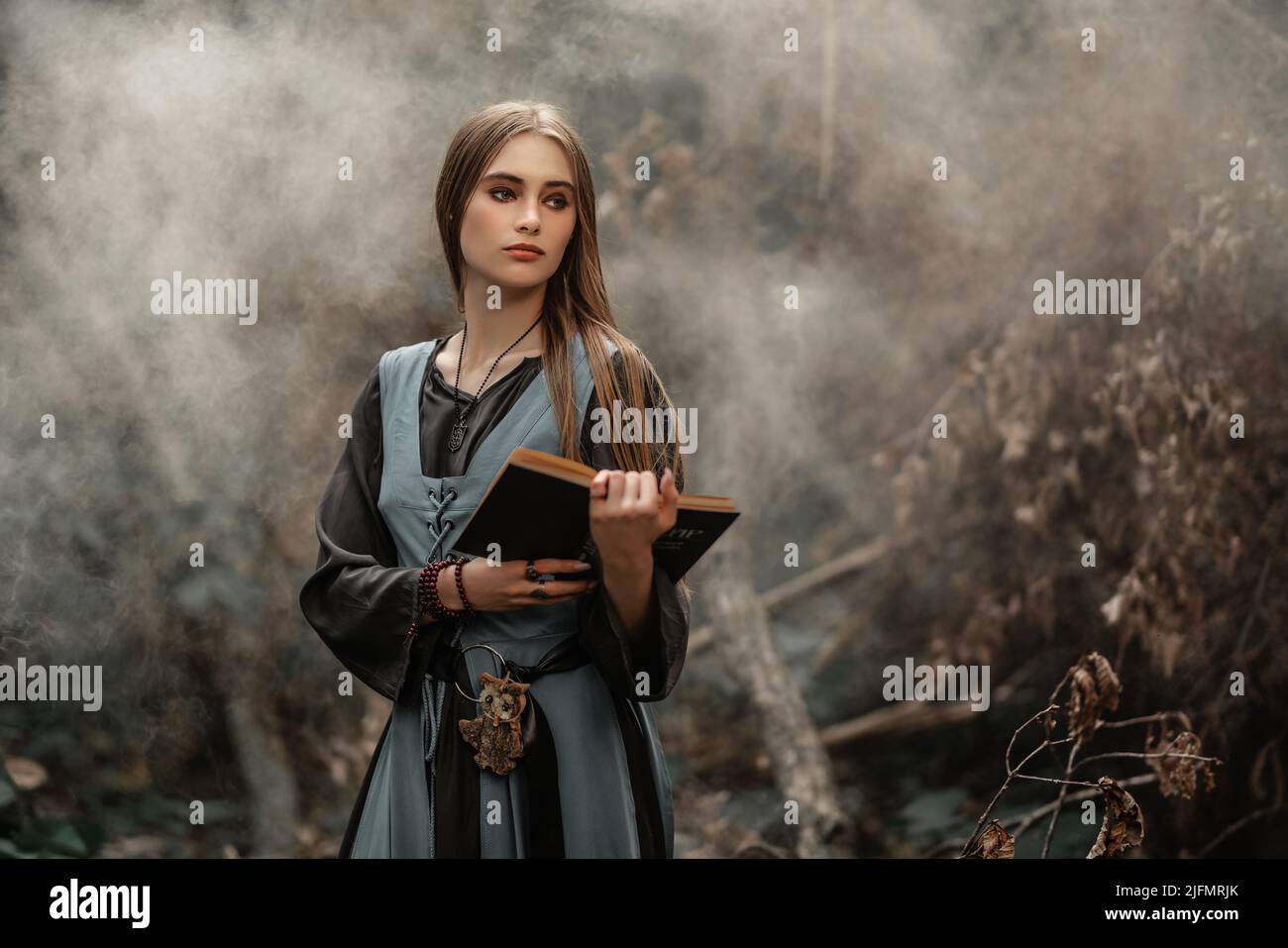 A mysterious witch walks in a dark forest Stock Photo - Alamy