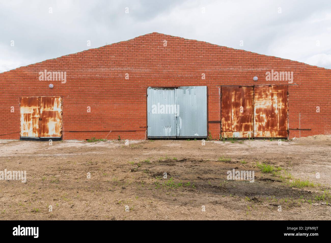Old closed and abandoned red brick cattle farm building. Rural ...