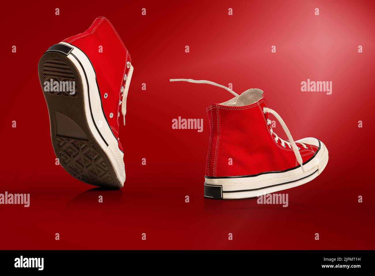 Strolling sneakers on red background. Sport shoes or trainers isolated ...
