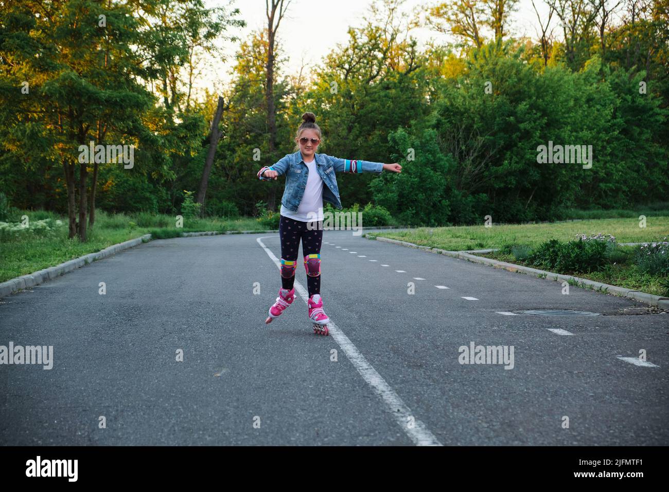 Girl riding roller skates in the park Stock Photo - Alamy