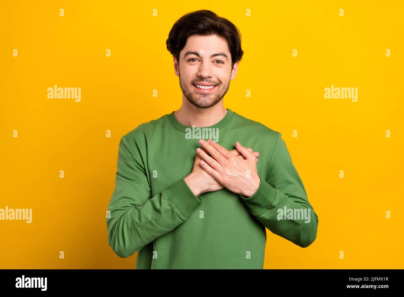 Photo of grateful sincere genuine guy crossed palms chest wear green ...