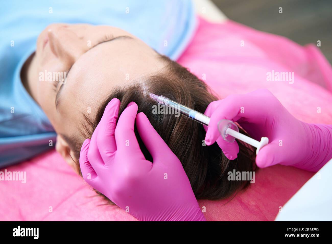 Man visiting beauty clinic for injections into head Stock Photo - Alamy