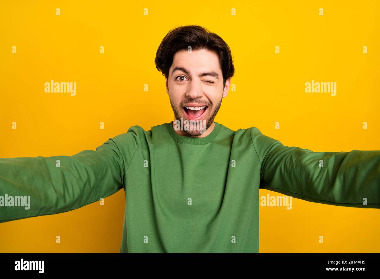 Photo of young cheerful happy positive man wink eye make selfie camera ...