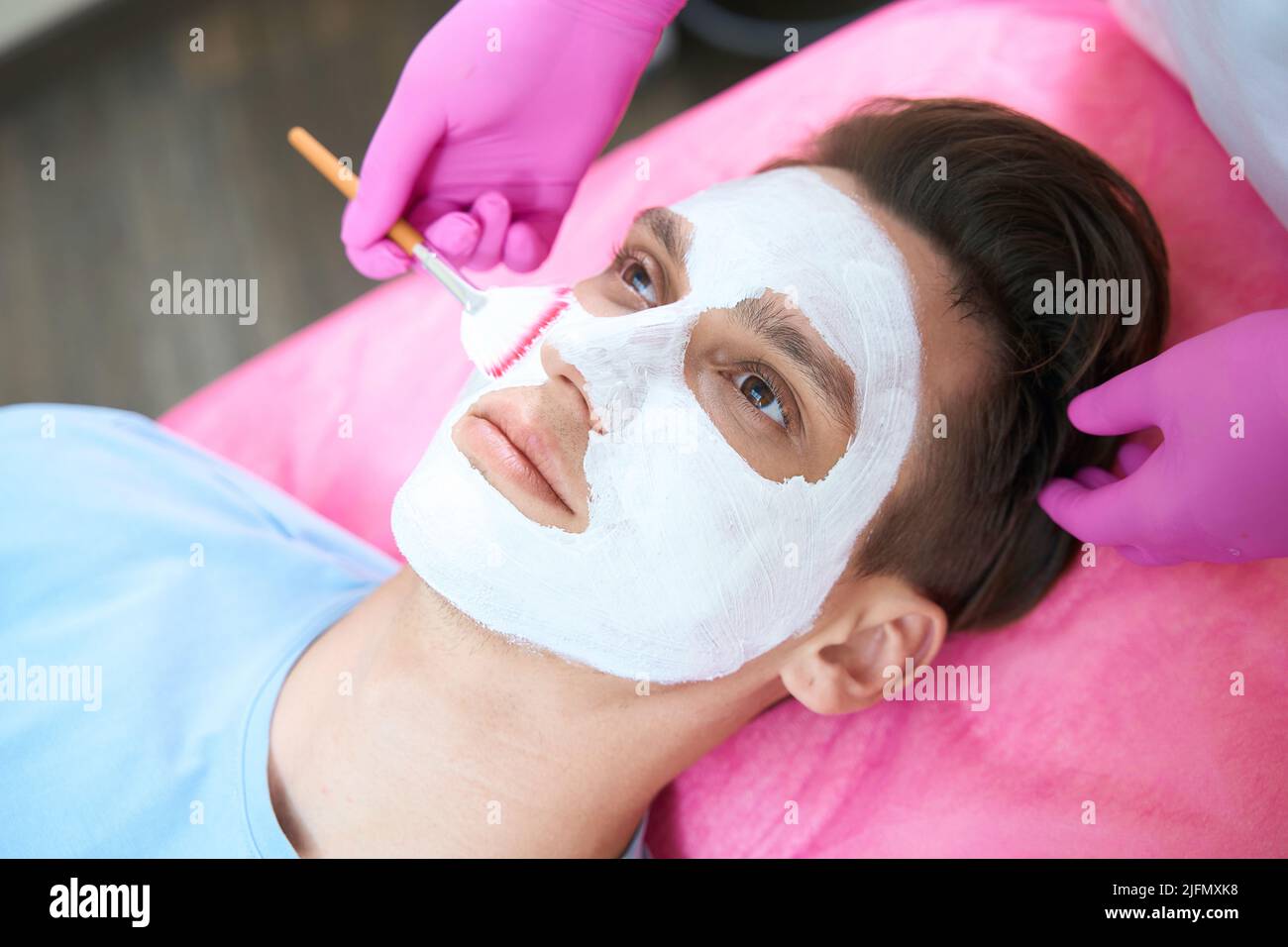 Professional beautician doing facial massage hi-res stock photography ...