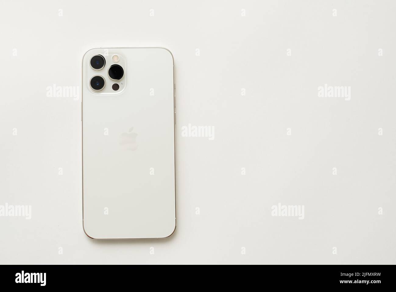 New white iPhone on white paper background Stock Photo - Alamy