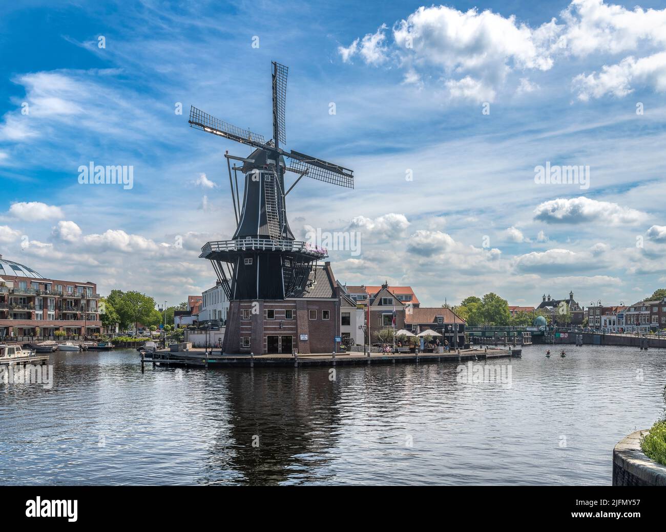 The iconic view of Holland with the Windmill De Adriaan. Plus canal ...
