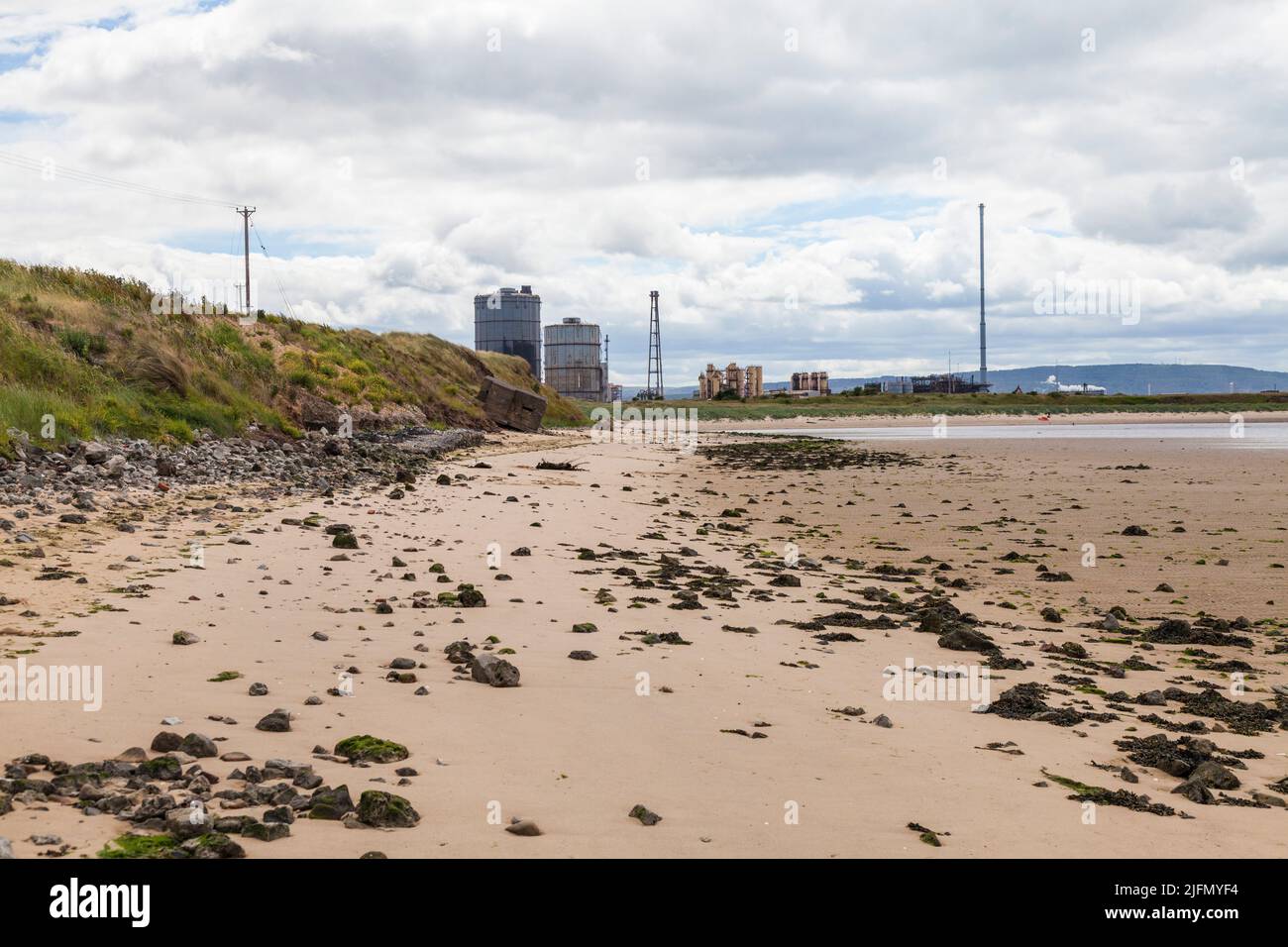 A view along the beach at Redcar,England,UK with the former steel works ...