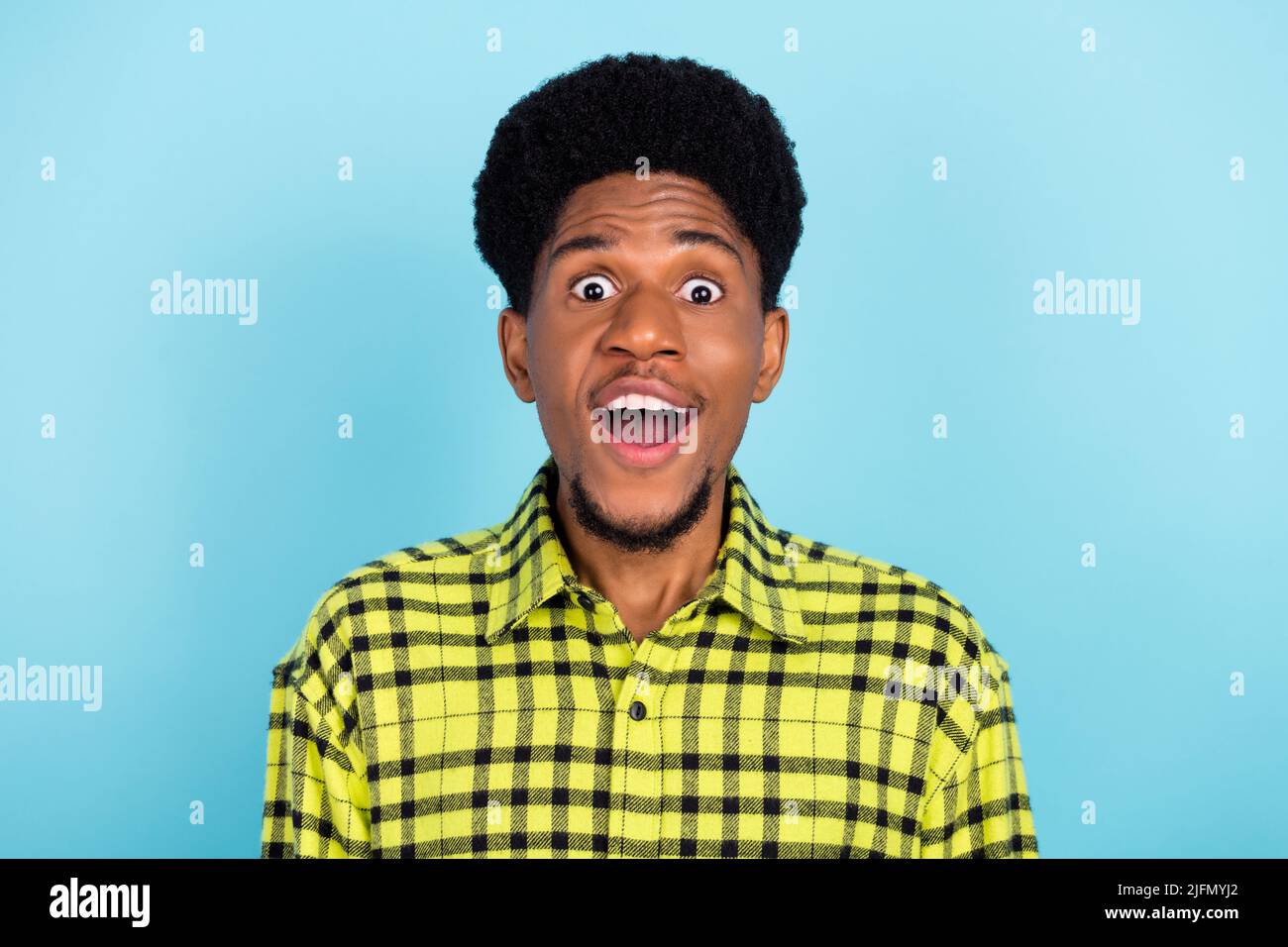 Photo of young brunette impressed guy wear yellow shirt isolated on ...