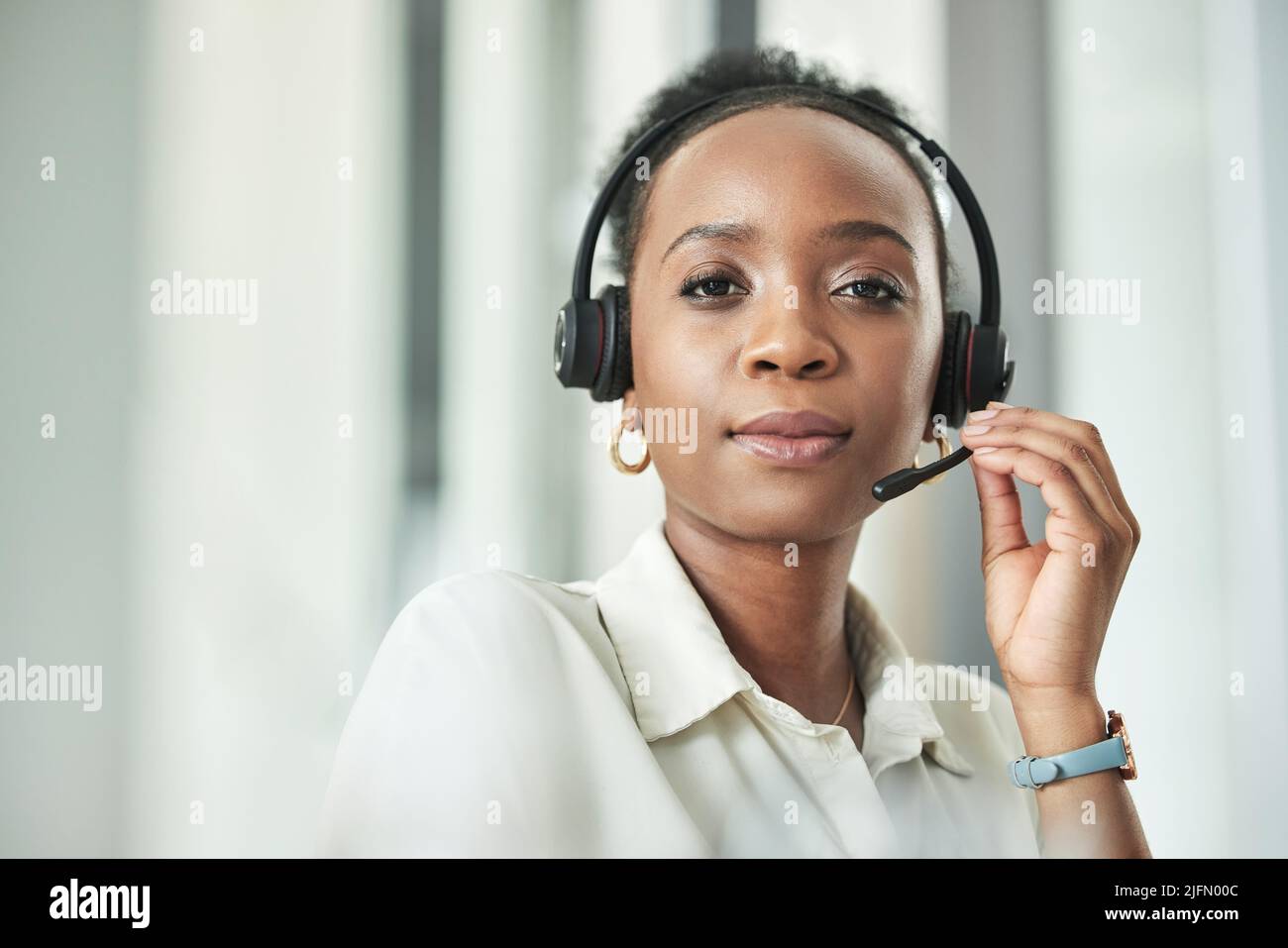 Im only a call away. Shot of an attractive young call centre agent ...