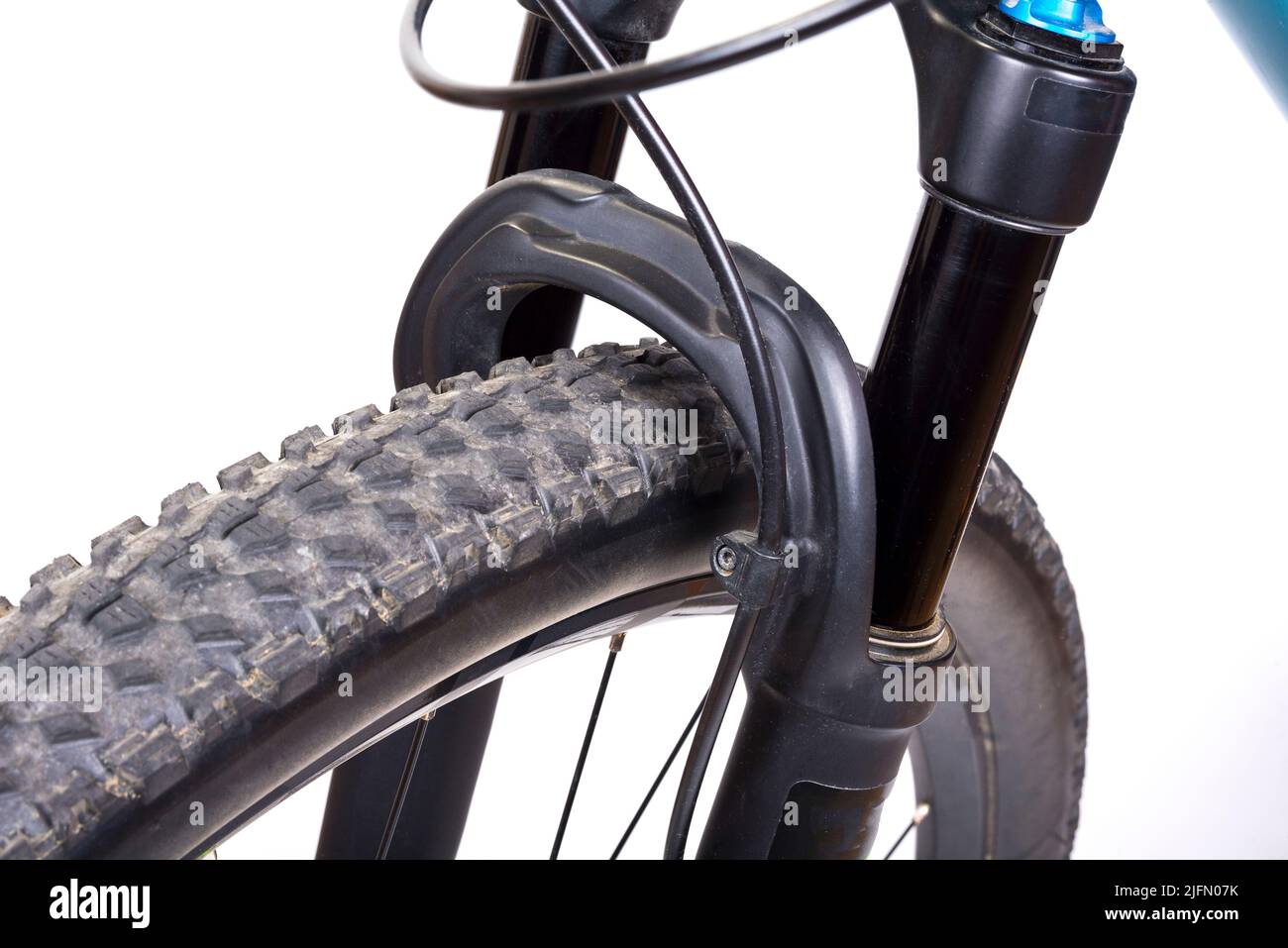 Mountain bicycle front fork with a wire for a brake and dirty tire ...