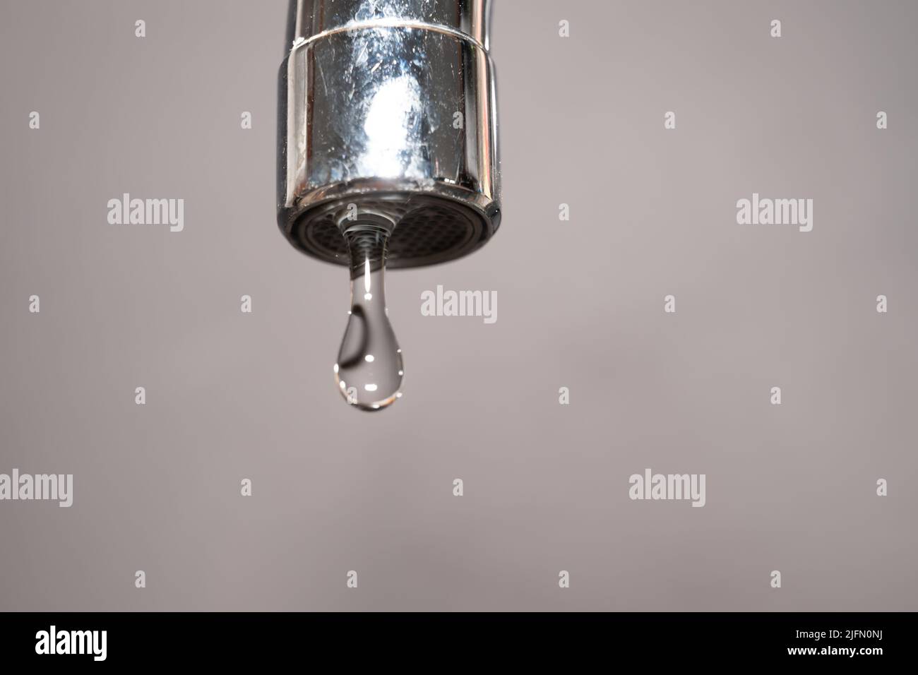 Tap from which drops of water flow. Drought, shortage, rationing and ...