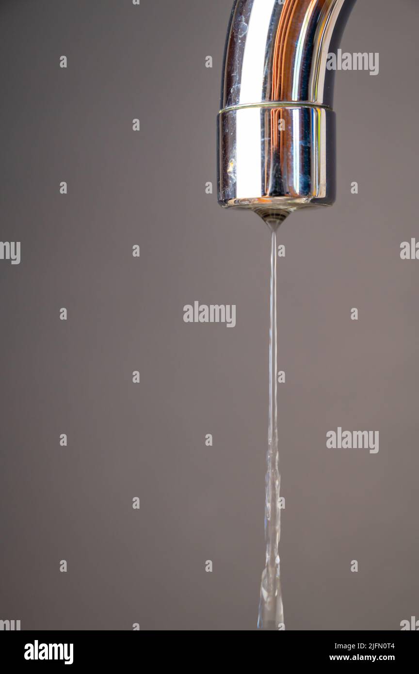 Tap from which drops of water flow. Drought, shortage, rationing and ...