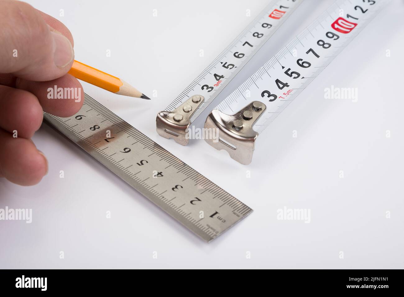 Steel ruler and tape meter with wood pencil on white Stock Photo - Alamy